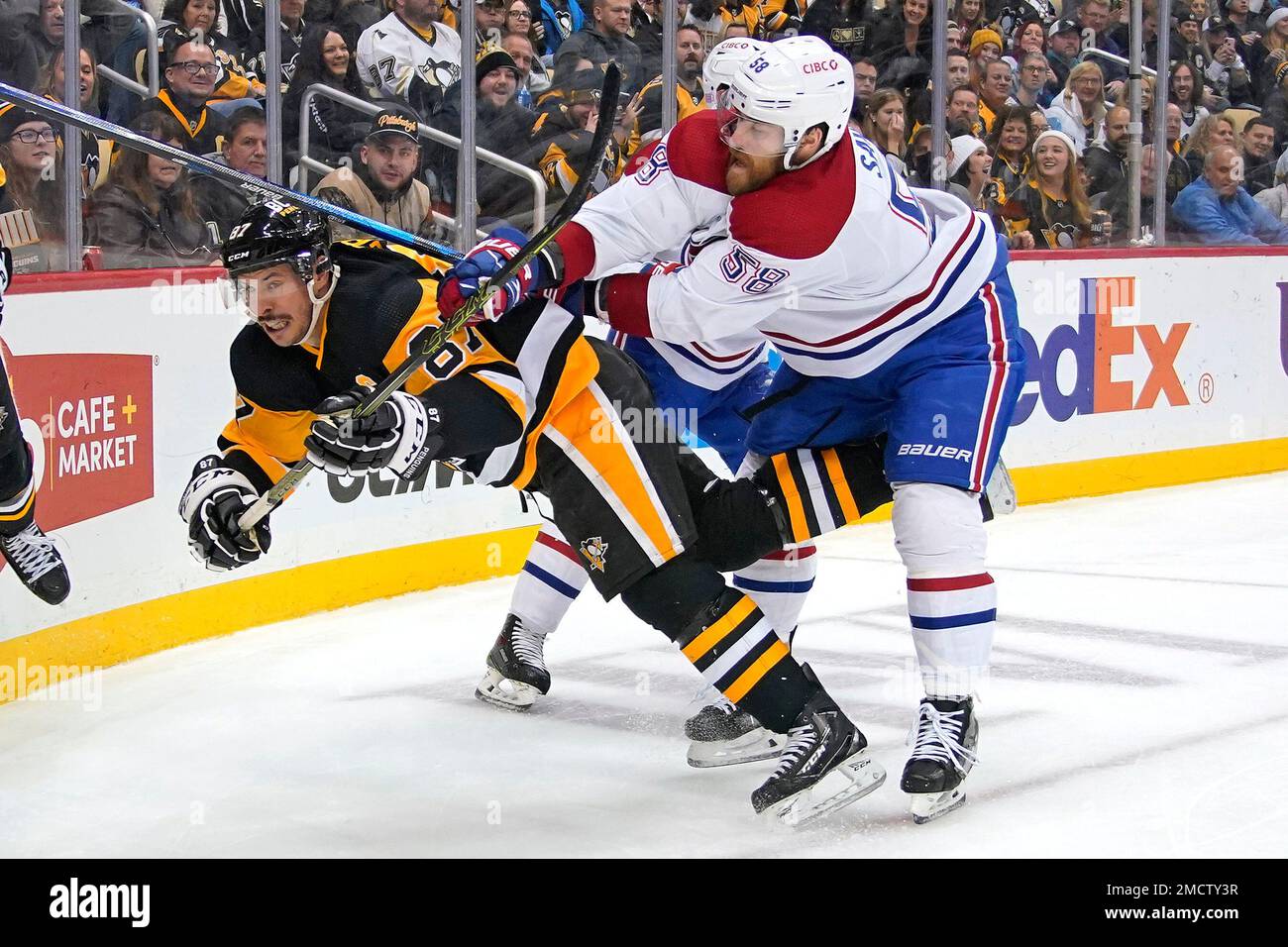 Pittsburgh Penguins' Sidney Crosby (87) is checked to the ice by ...