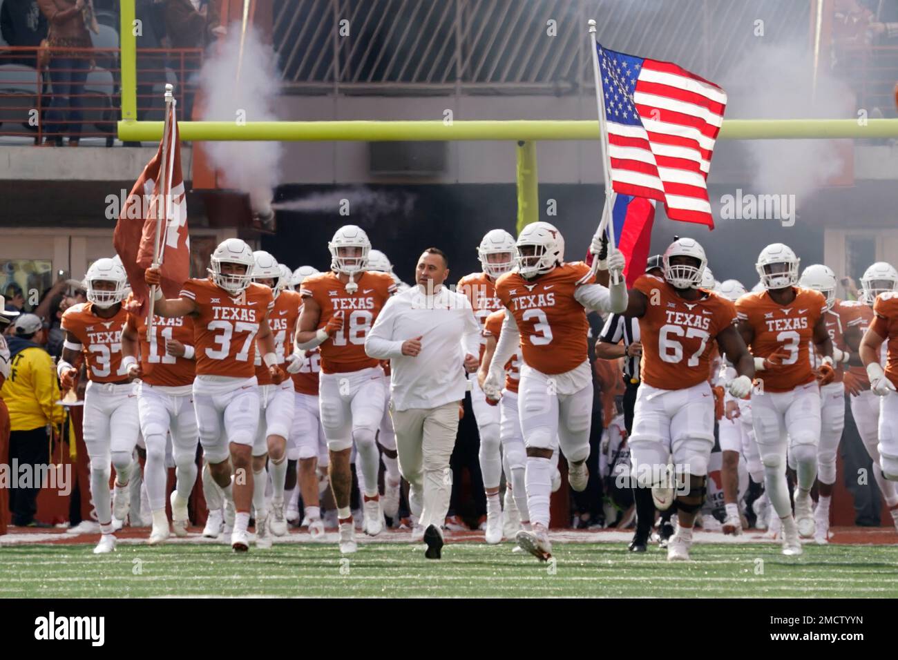 Texas head coach Steve Sarkisian leads the team as they take the field ...