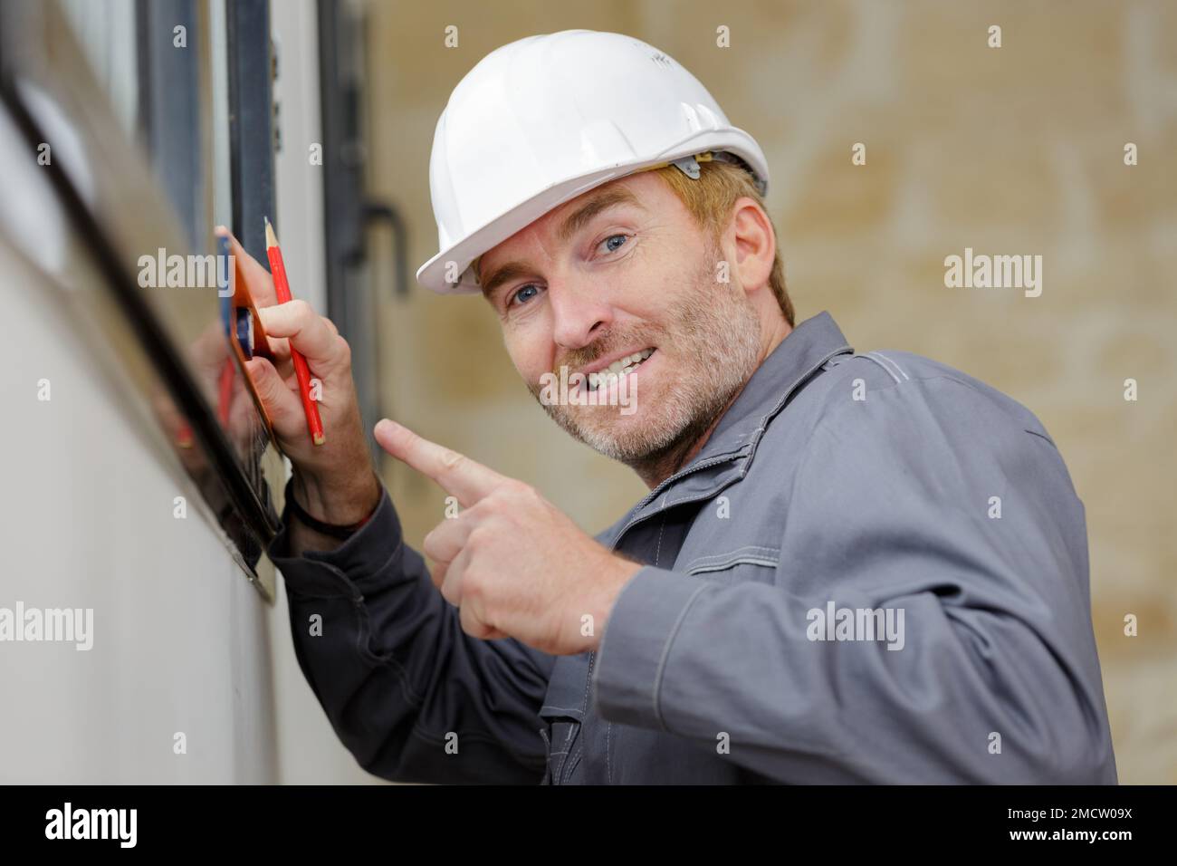 jolly smiling constructor looking at camera Stock Photo - Alamy