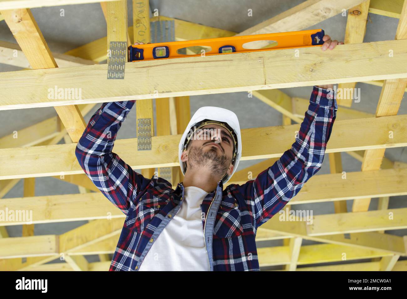 happy male construction worker adjusting ceiling Stock Photo - Alamy