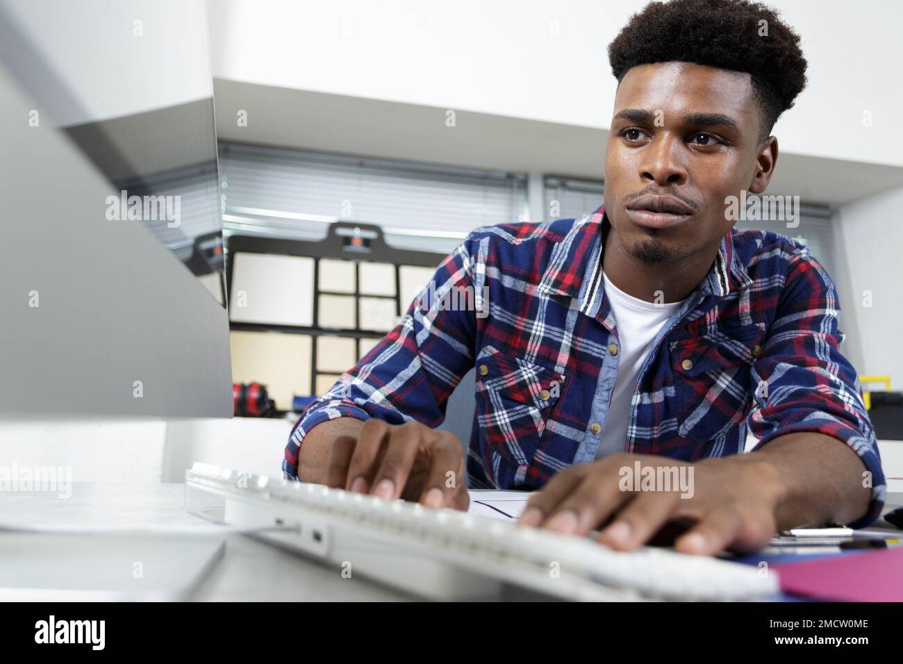 man typing on computer keyboard in office Stock Photo - Alamy