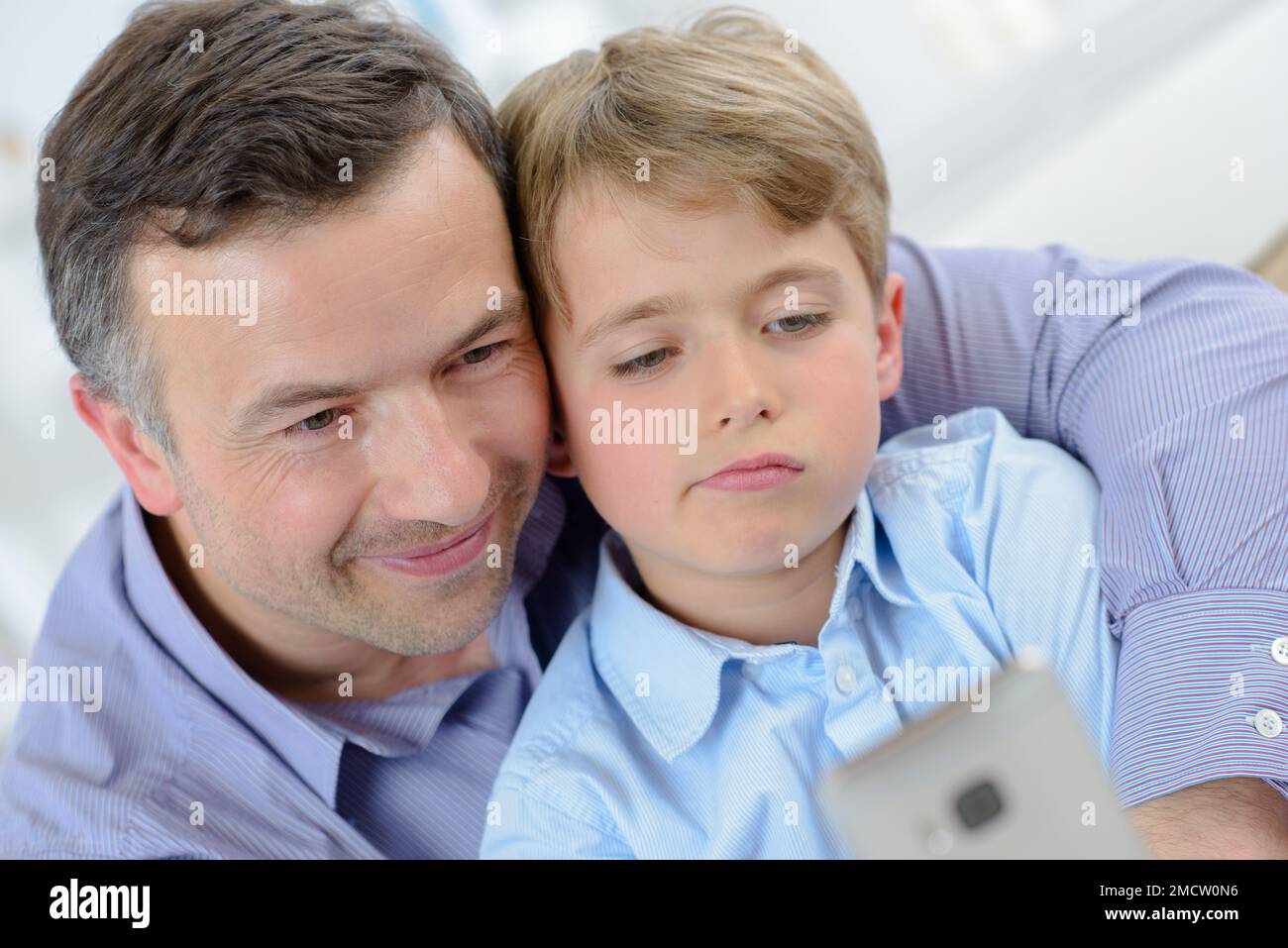 parents sending a text message Stock Photo - Alamy