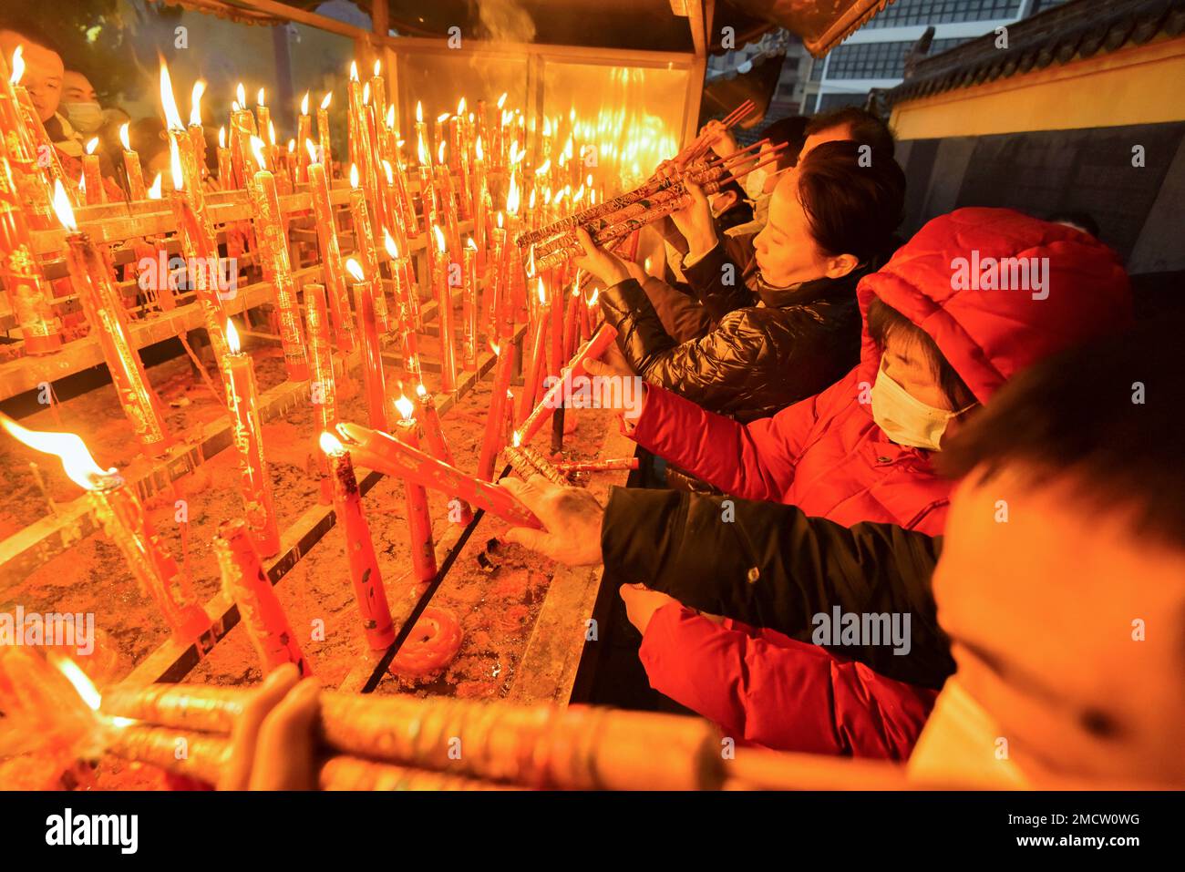 People burn incense and pray for good luck at the Zifu Temple in Fuyang ...