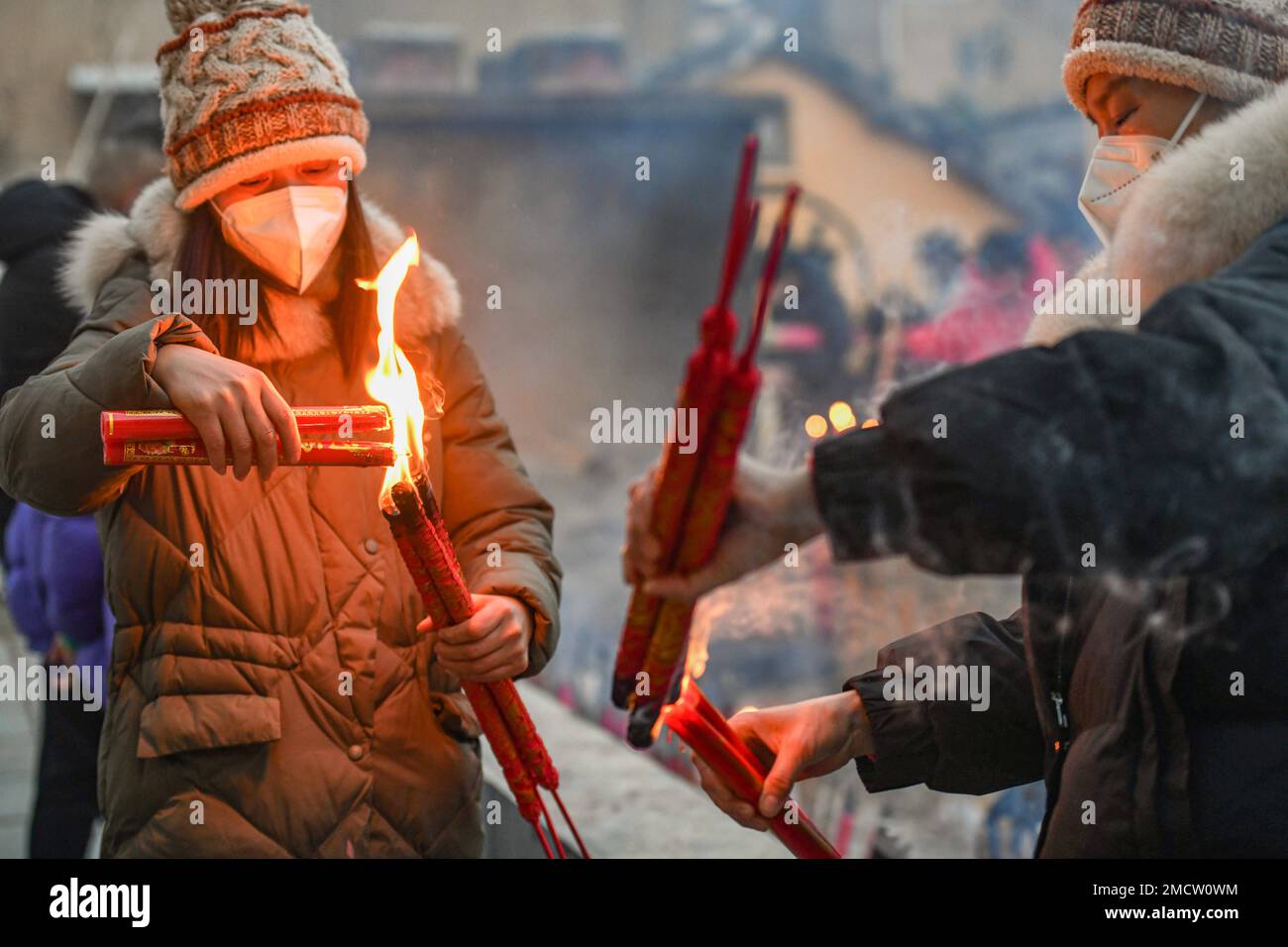People burn incense and pray for good luck at the Zifu Temple in Fuyang ...