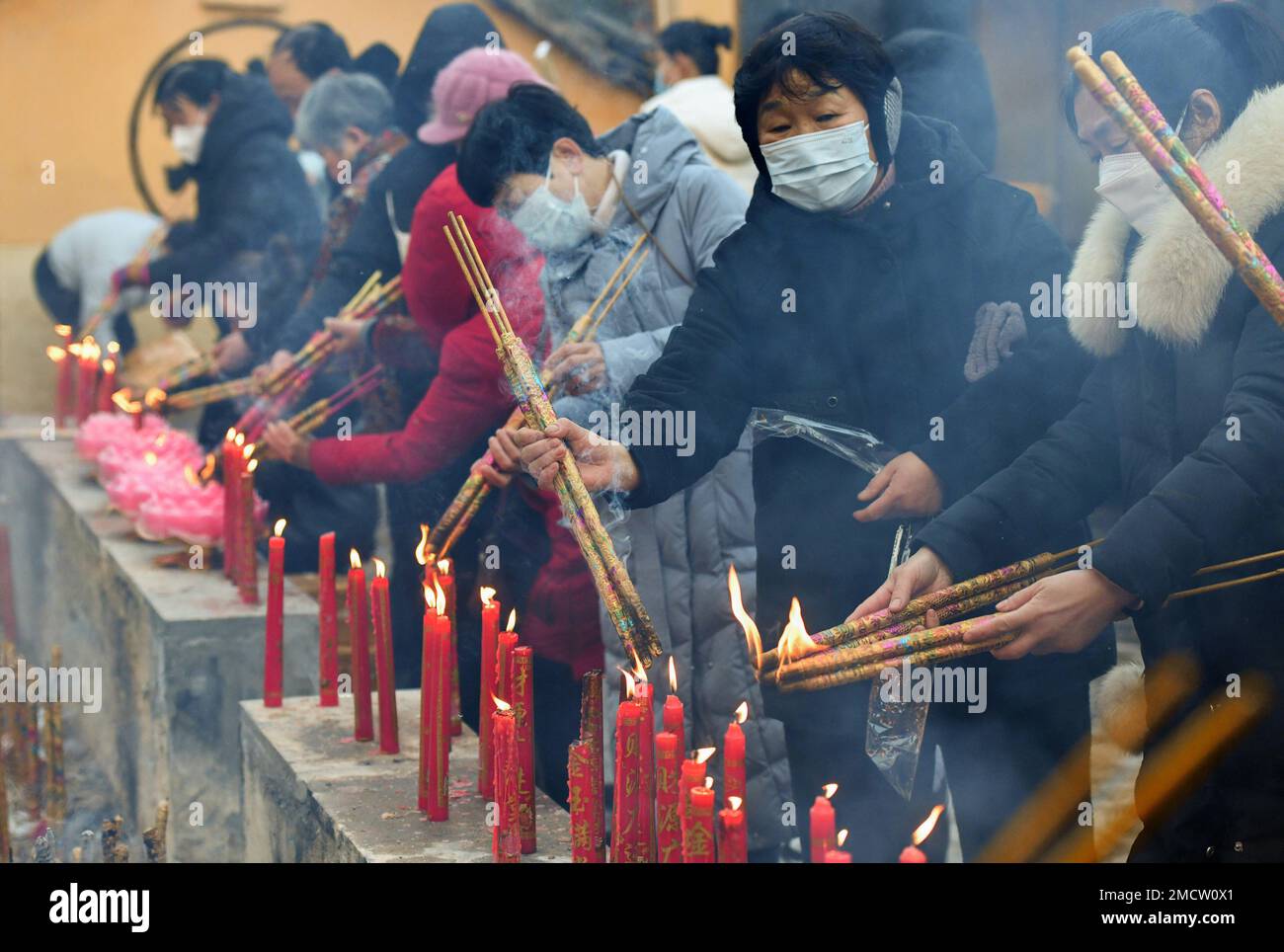 People burn incense and pray for good luck at the Zifu Temple in Fuyang ...