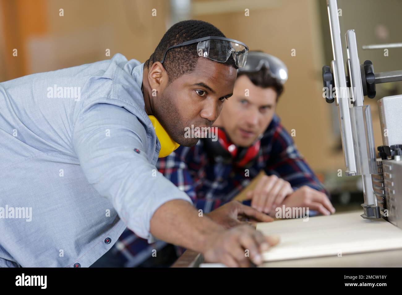 two carpenters workers joint and settle home built-in cupboard Stock ...