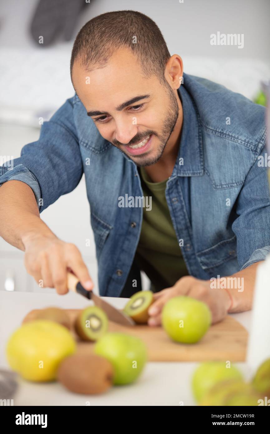 young man preparing fresh fruits Stock Photo - Alamy
