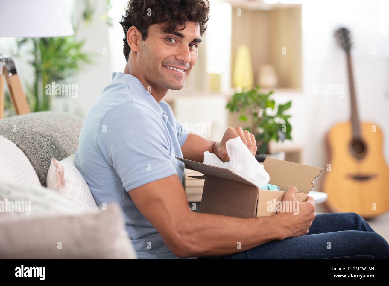 happy man opening parcel box at home Stock Photo - Alamy