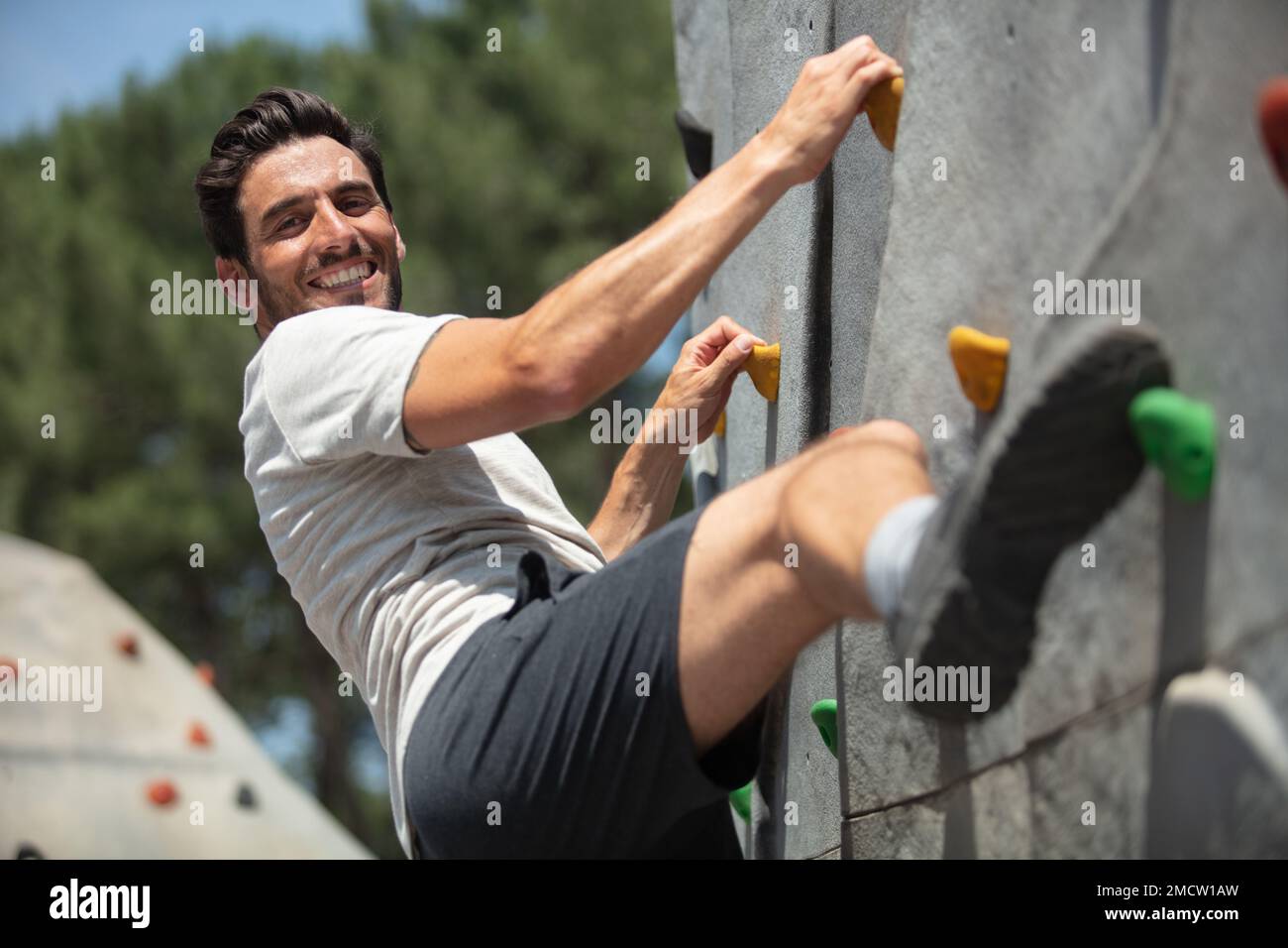 portrait of man on artificial climbing wall Stock Photo - Alamy