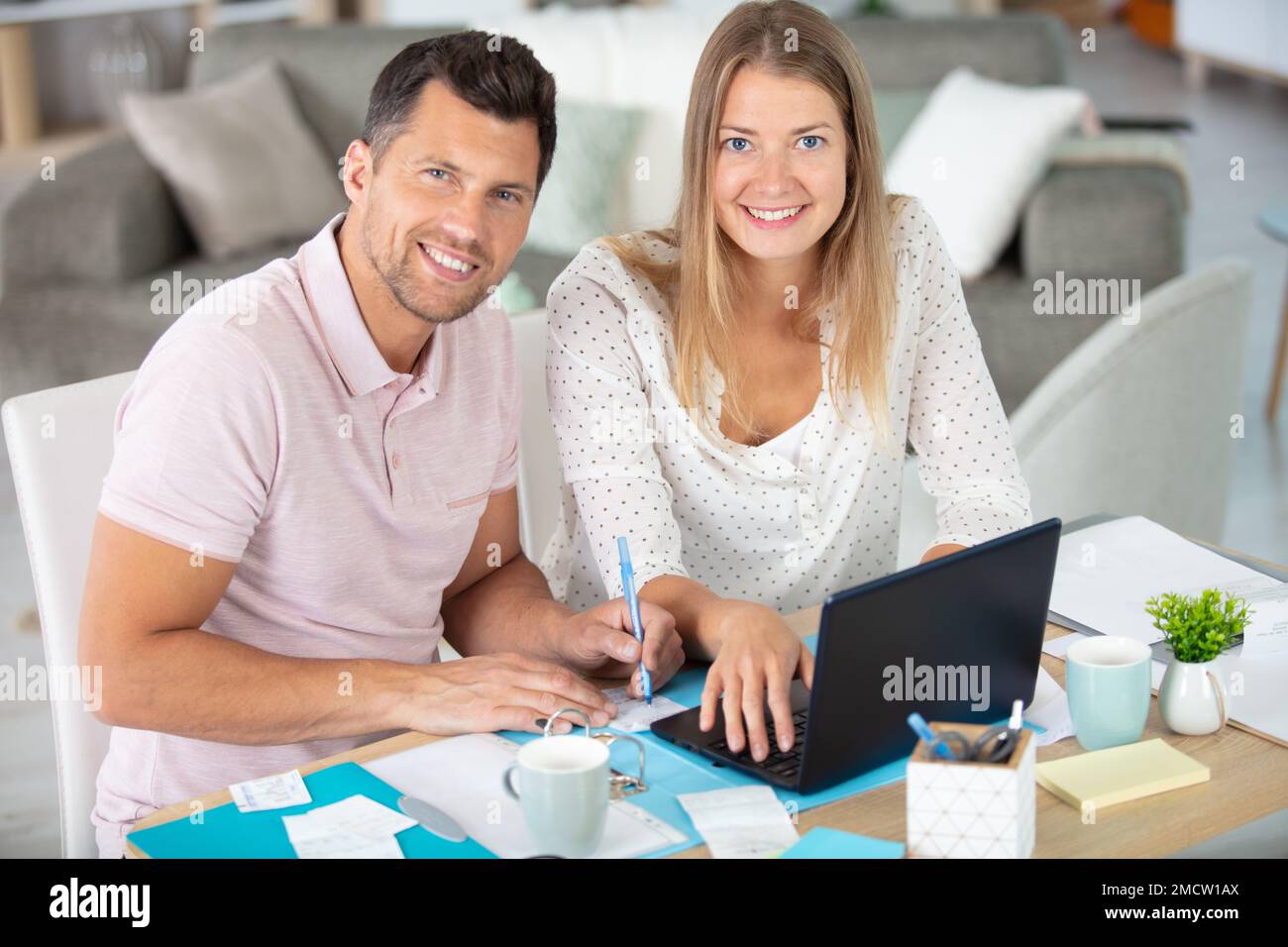 happy couple after calculating income Stock Photo - Alamy