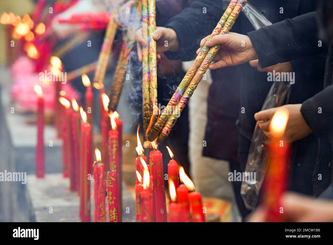People burn incense and pray for good luck at the Zifu Temple in Fuyang ...