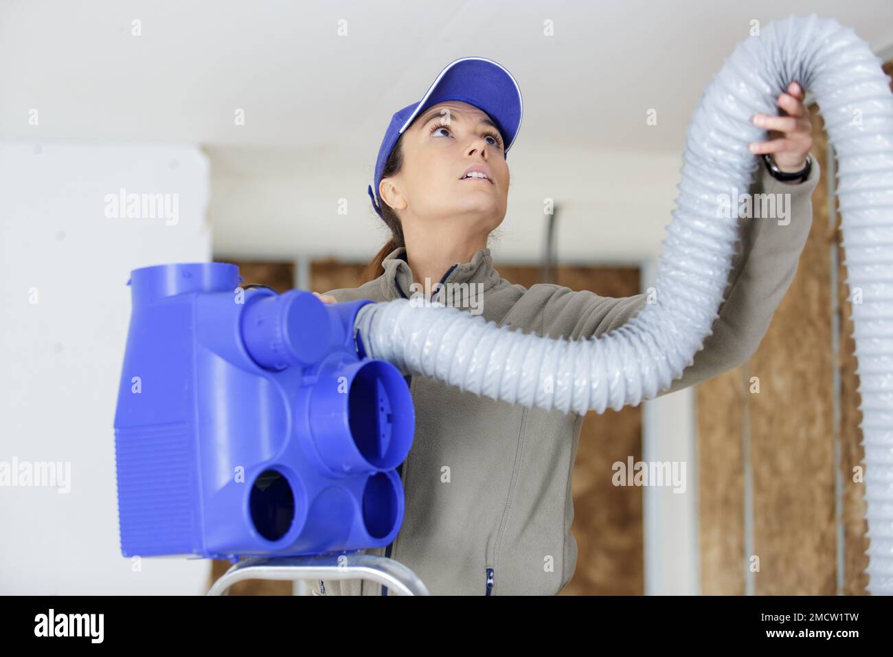 female operator inspecting heating ventilated system Stock Photo - Alamy
