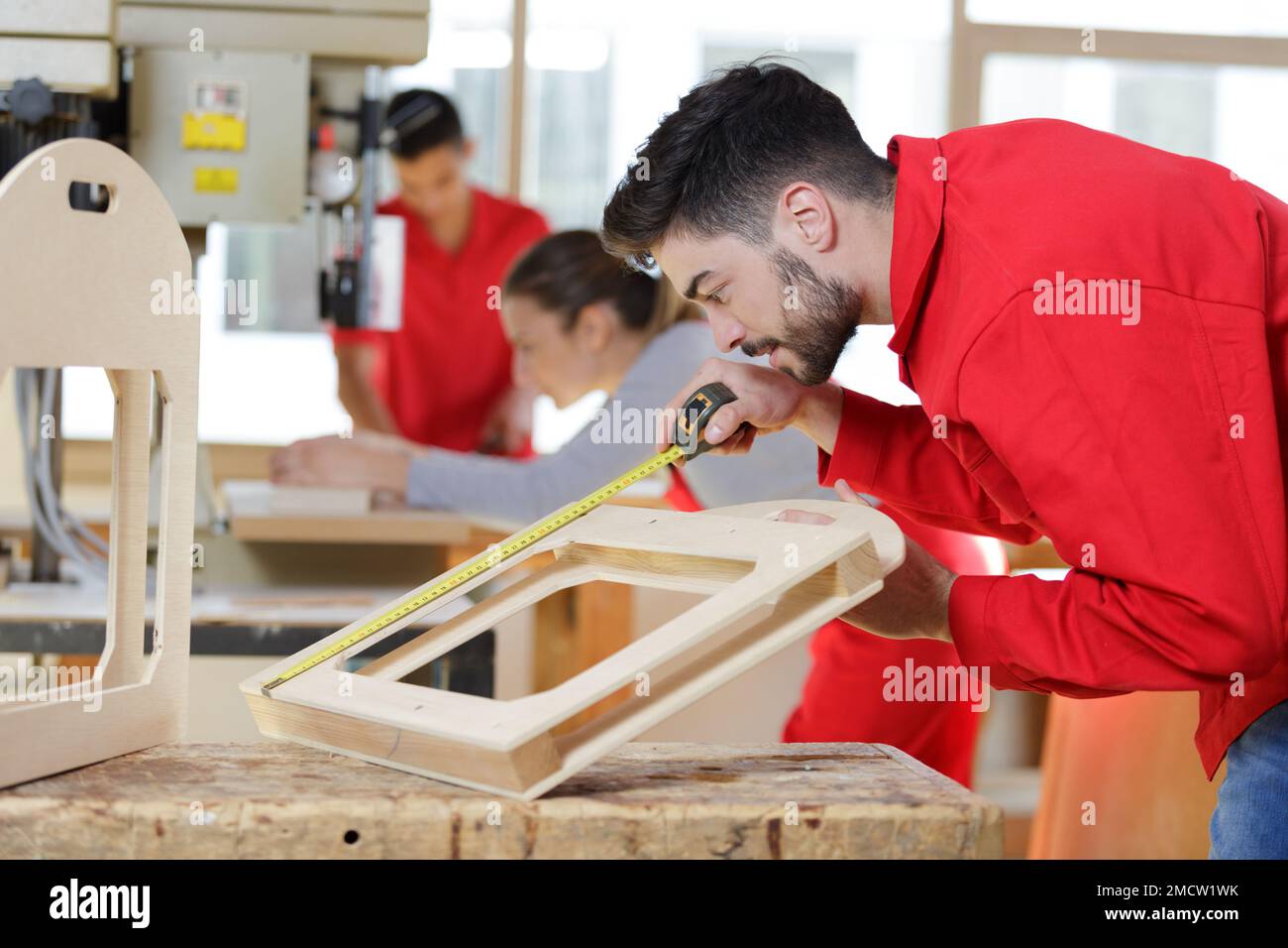 a contractor measuring wood frame Stock Photo - Alamy