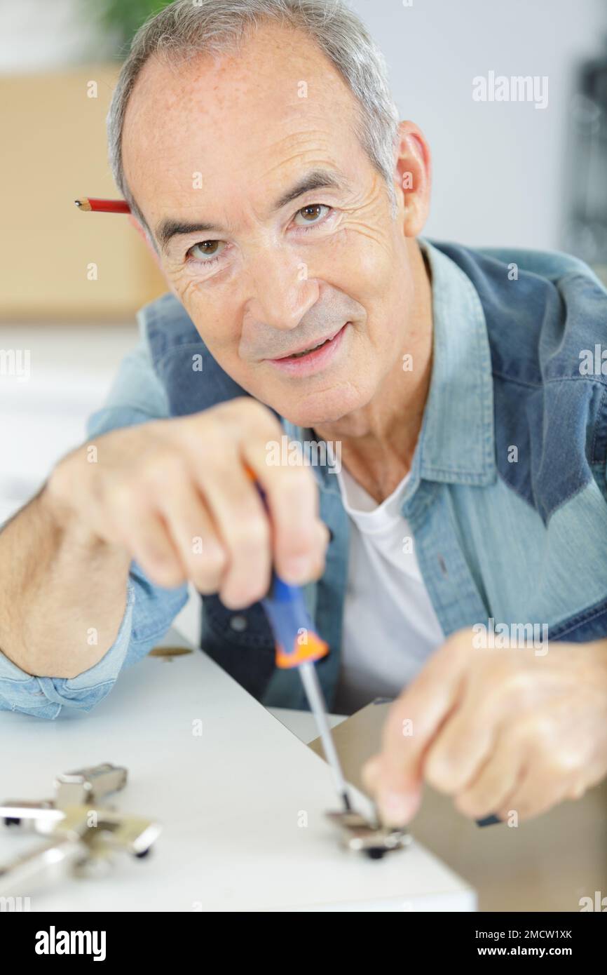 senior man during furniture assembly Stock Photo - Alamy