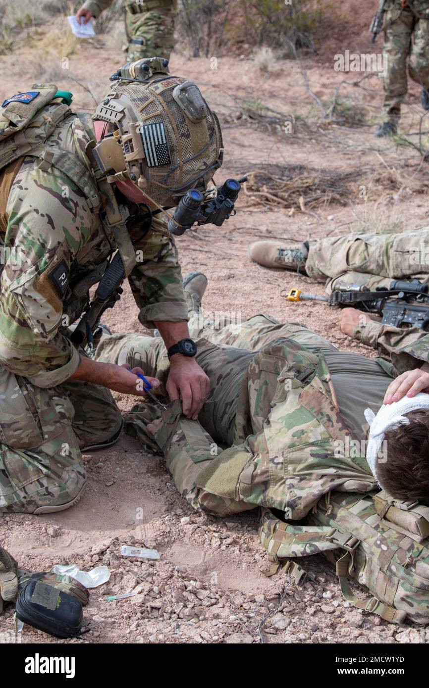 A 306th Rescue Squadron pararescueman cuts into the uniform of an ...