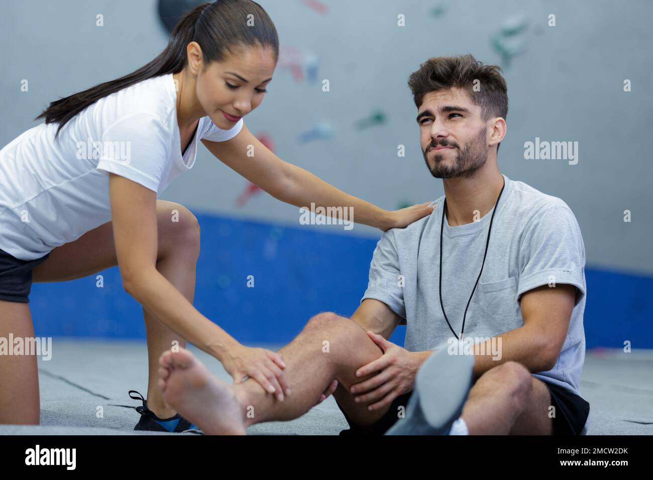 first aider helping climber with injured leg Stock Photo - Alamy