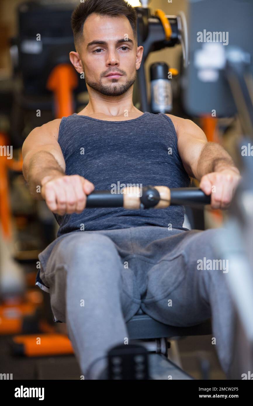 muscular man exercising on a rowing machine Stock Photo - Alamy