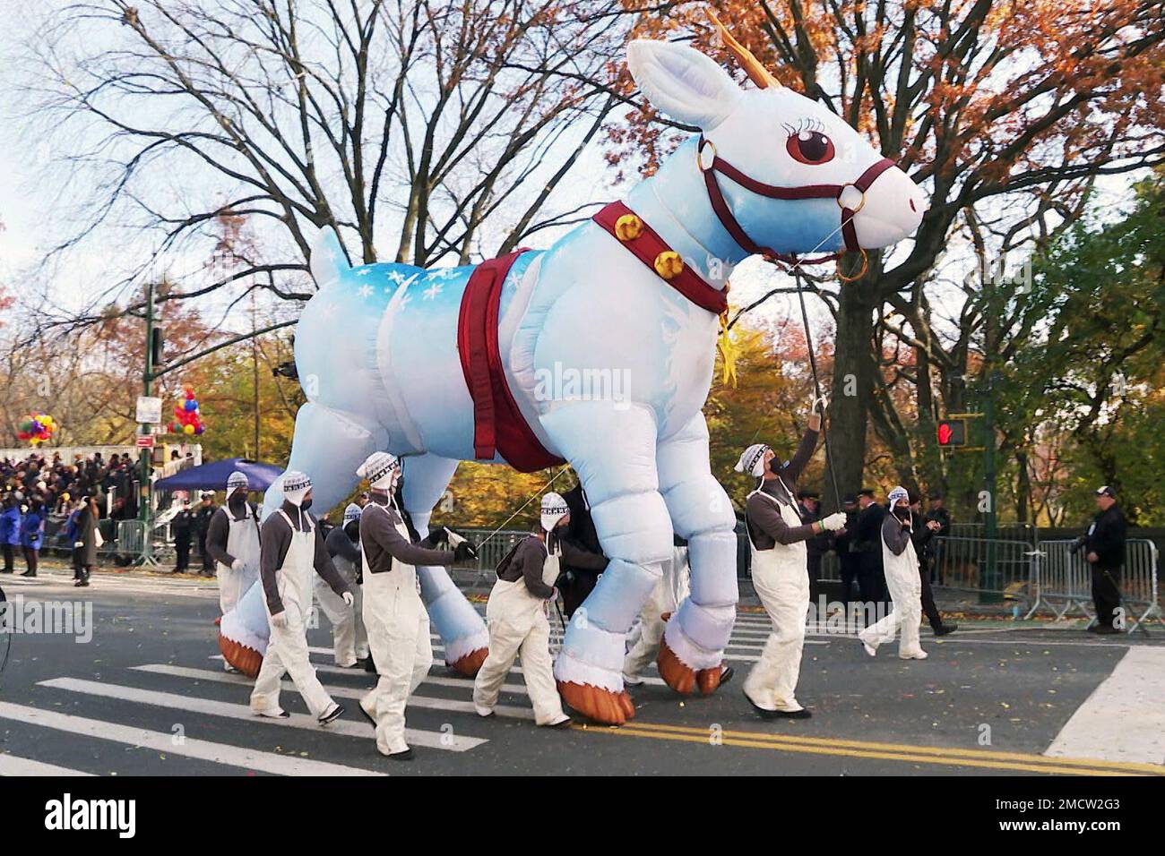 Handlers trot the Tiptoe reindeer balloon puppet down Central Park West ...