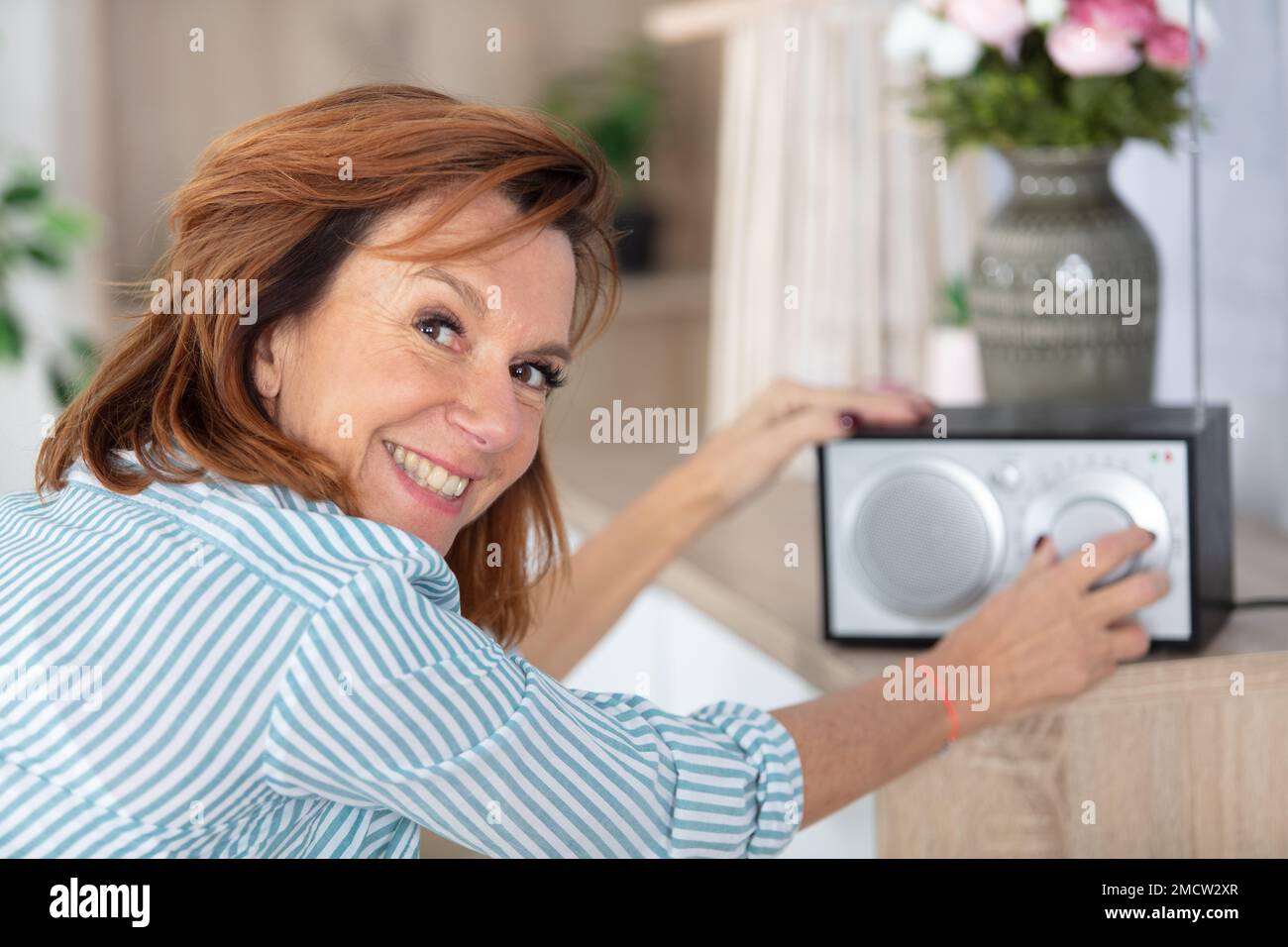 woman listening to music via the hi-fi stereo Stock Photo - Alamy