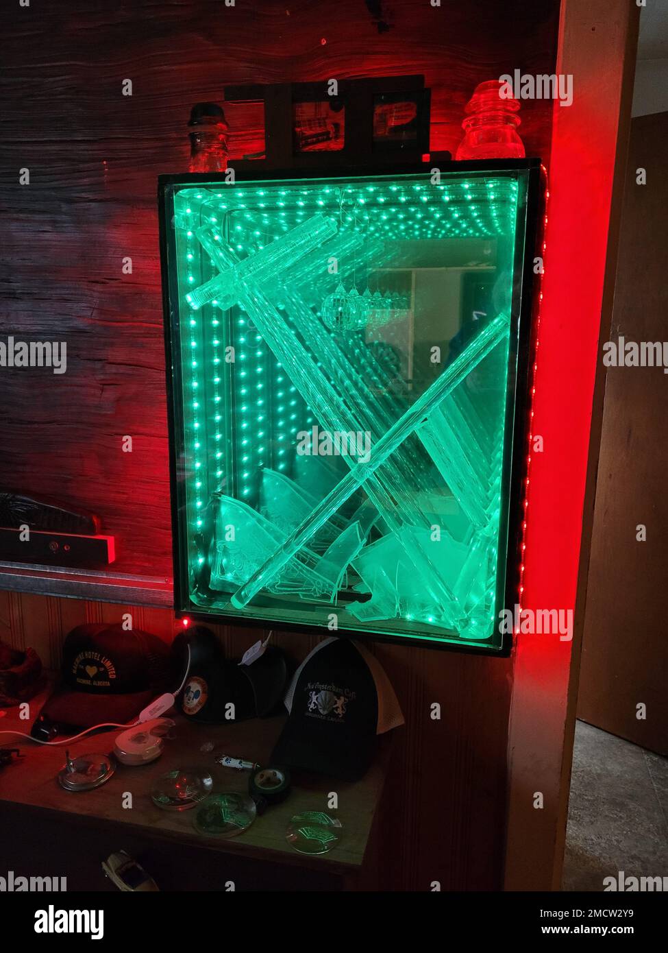 A green mirror with the infinity effect with red lights in the ...
