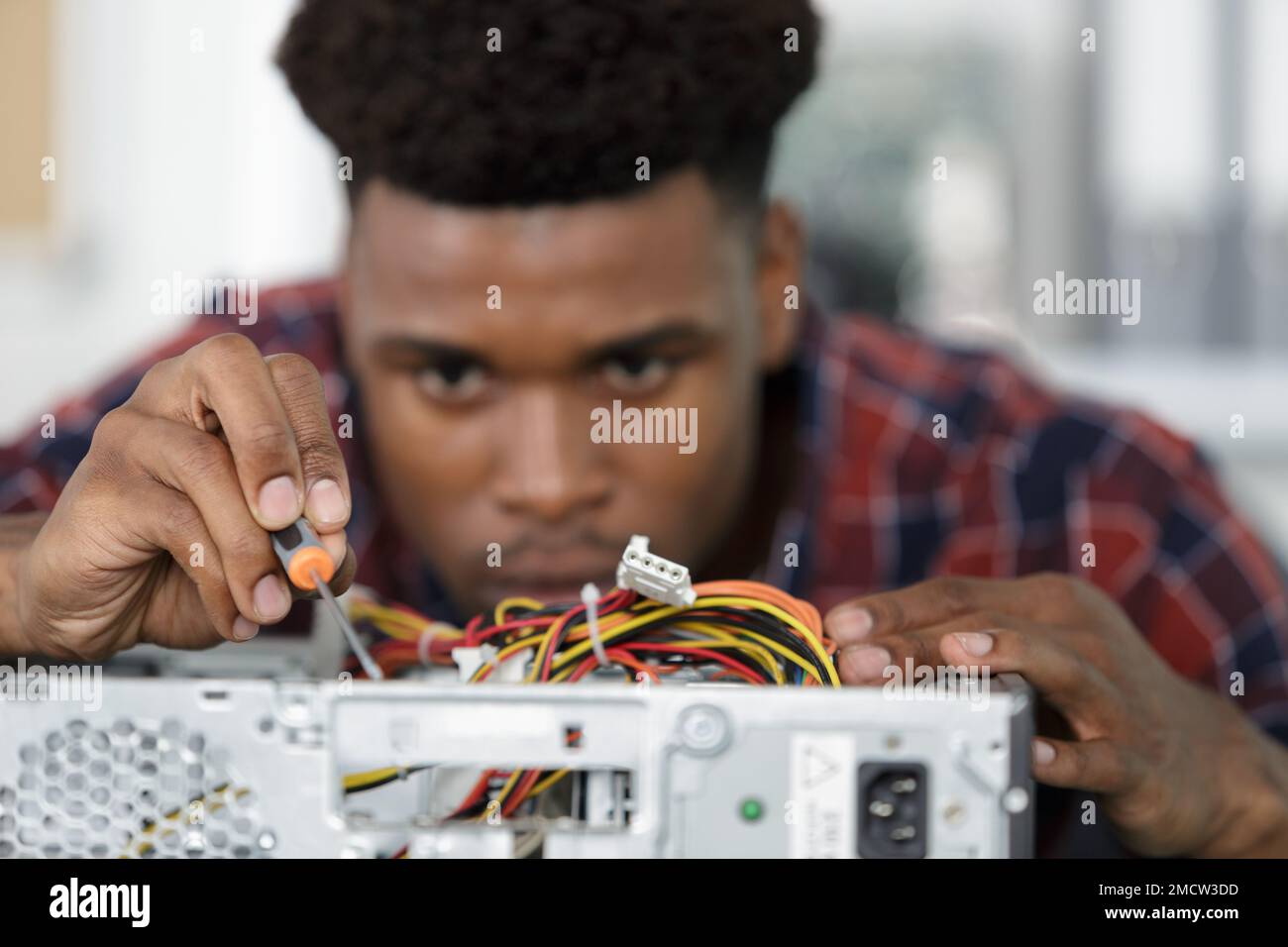 man is repairing broken pc with a screw driver Stock Photo - Alamy