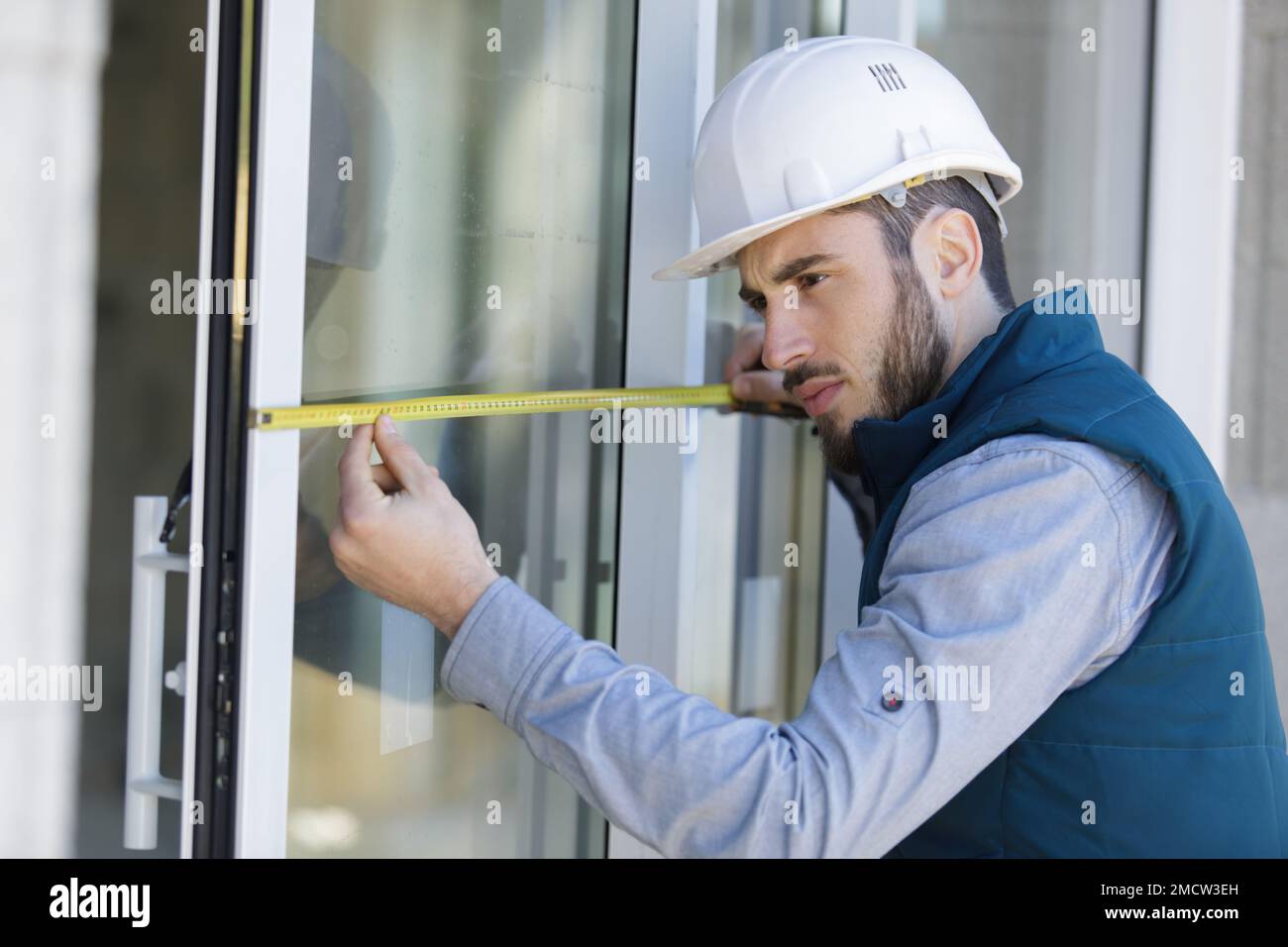young male worker measuring window Stock Photo - Alamy