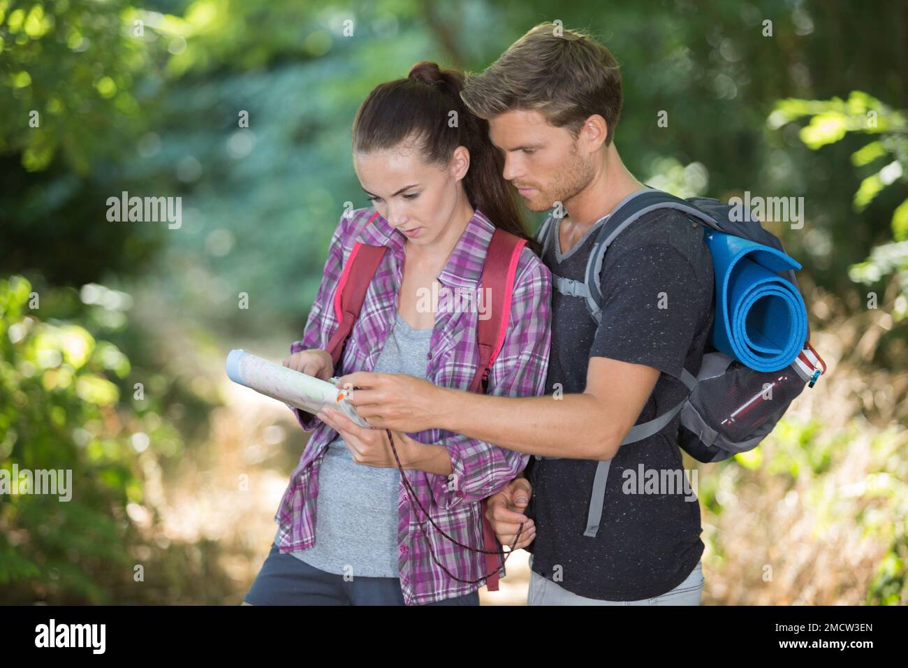 two hiker checking map Stock Photo - Alamy
