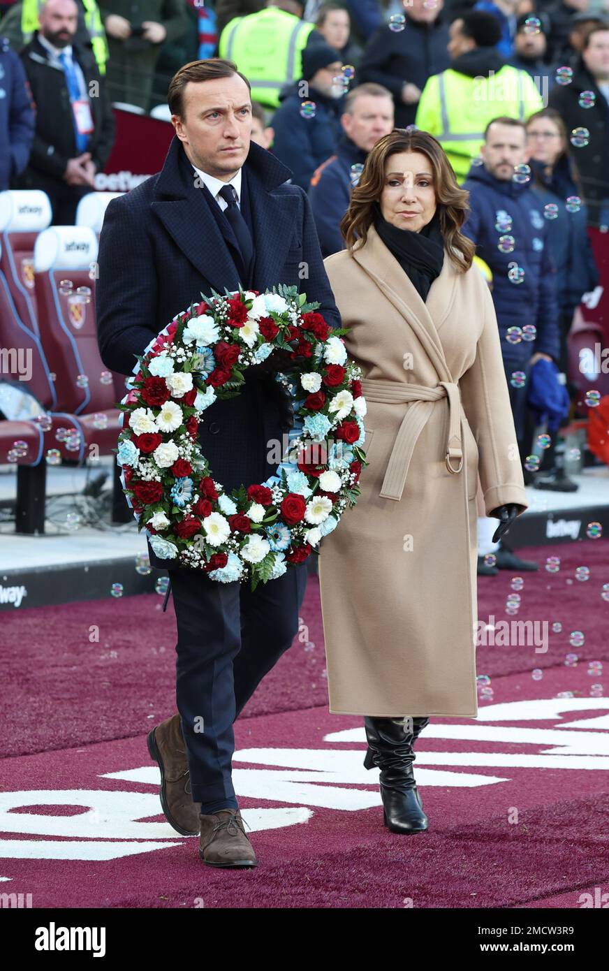 Mark Noble and his wife Carly Noble walks on with floral tribute to ...