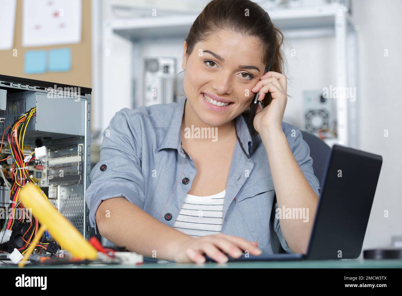 happy woman taking care of a broken pc Stock Photo - Alamy
