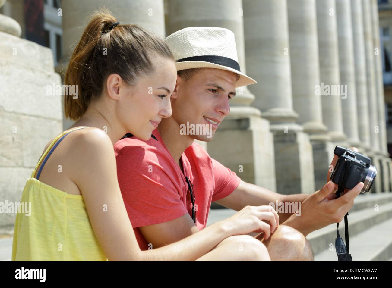 young couple checking picture on the camera Stock Photo - Alamy