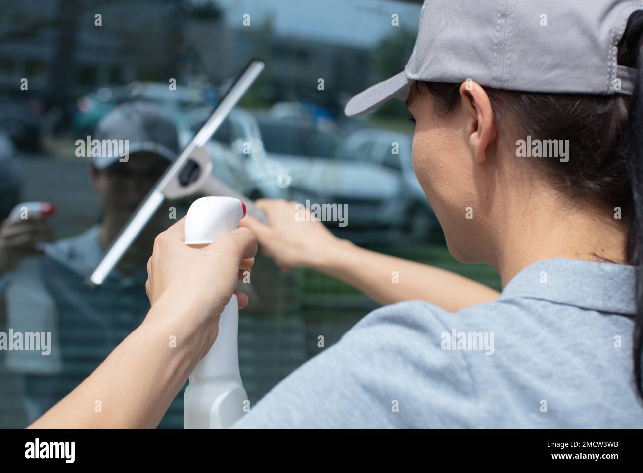 a woman is washing a window Stock Photo - Alamy