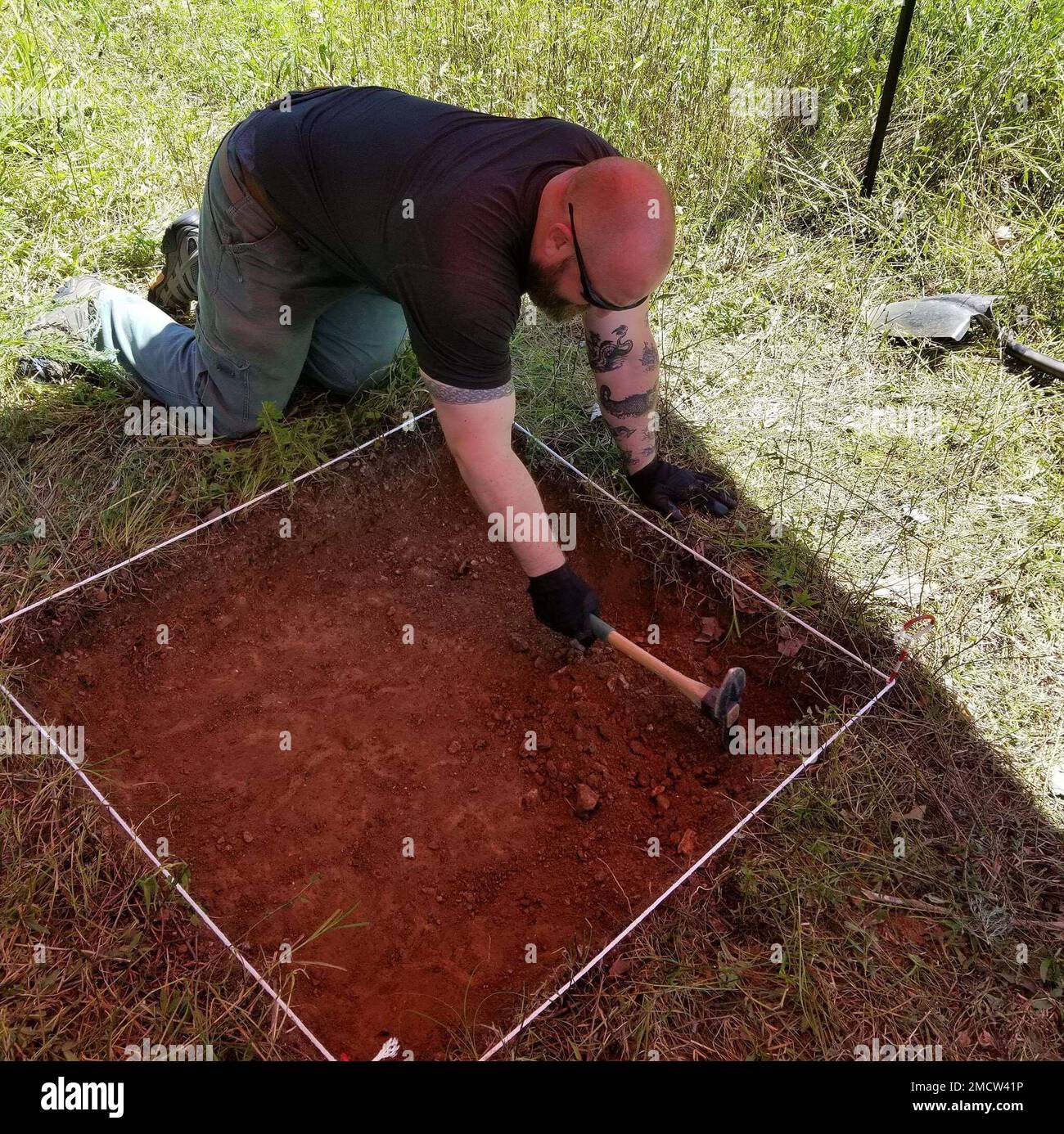 SWL Archaeologist, Allen Wilson digs holes in a grid pattern during a ...