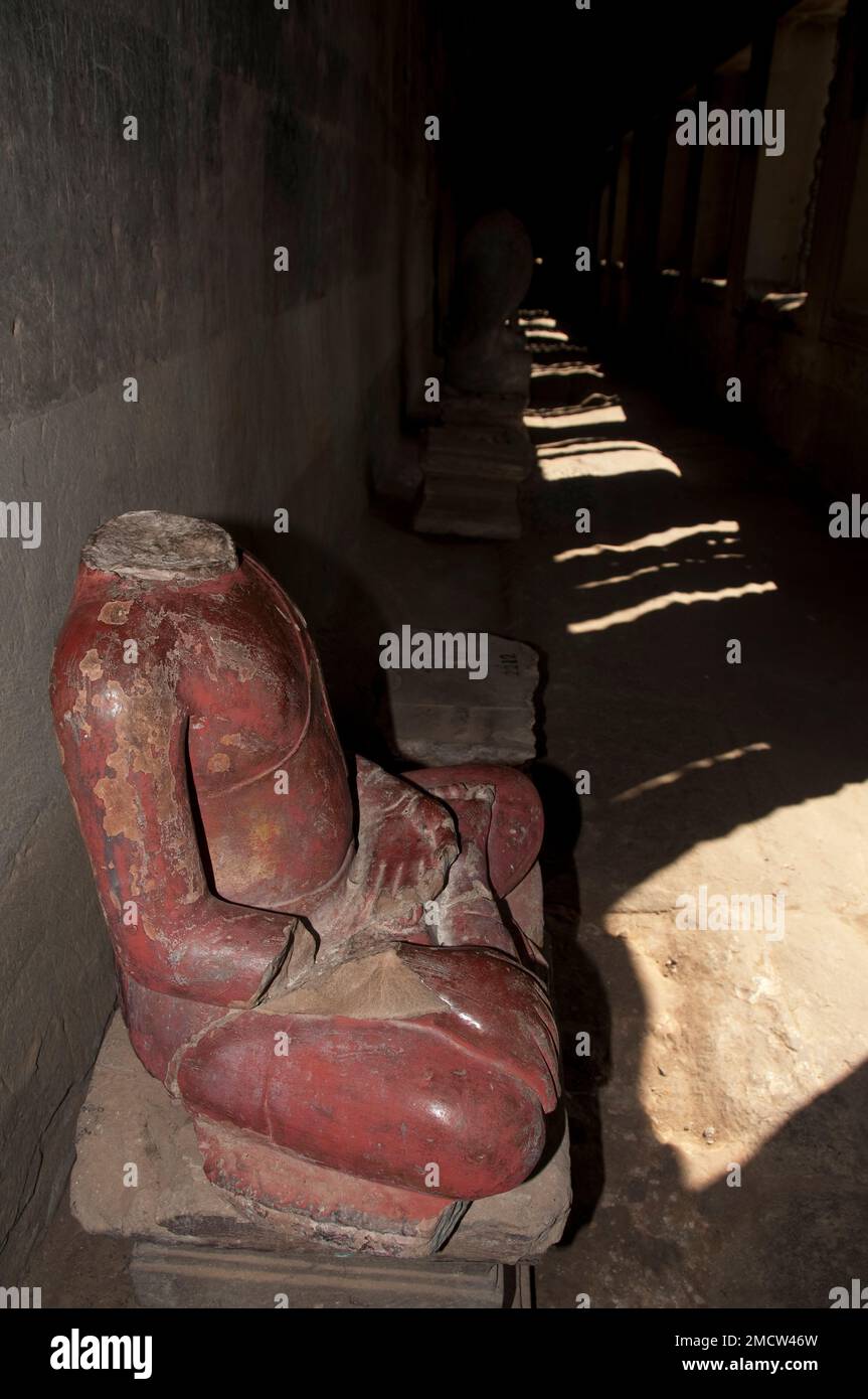 Headless red seated statue in corridor, Angkor Wat, Siem Riep, Cambodia ...