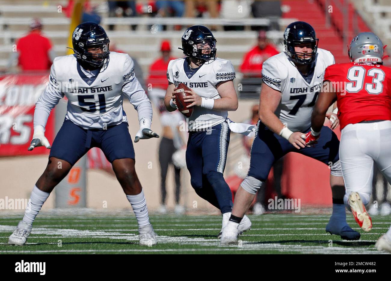 Utah State quarterback Logan Bonner, center, looks to throw a pass ...