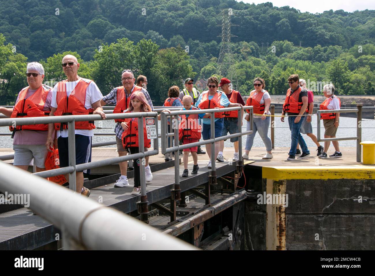 Members of the community cross a miter gate during a tour of Allegheny ...