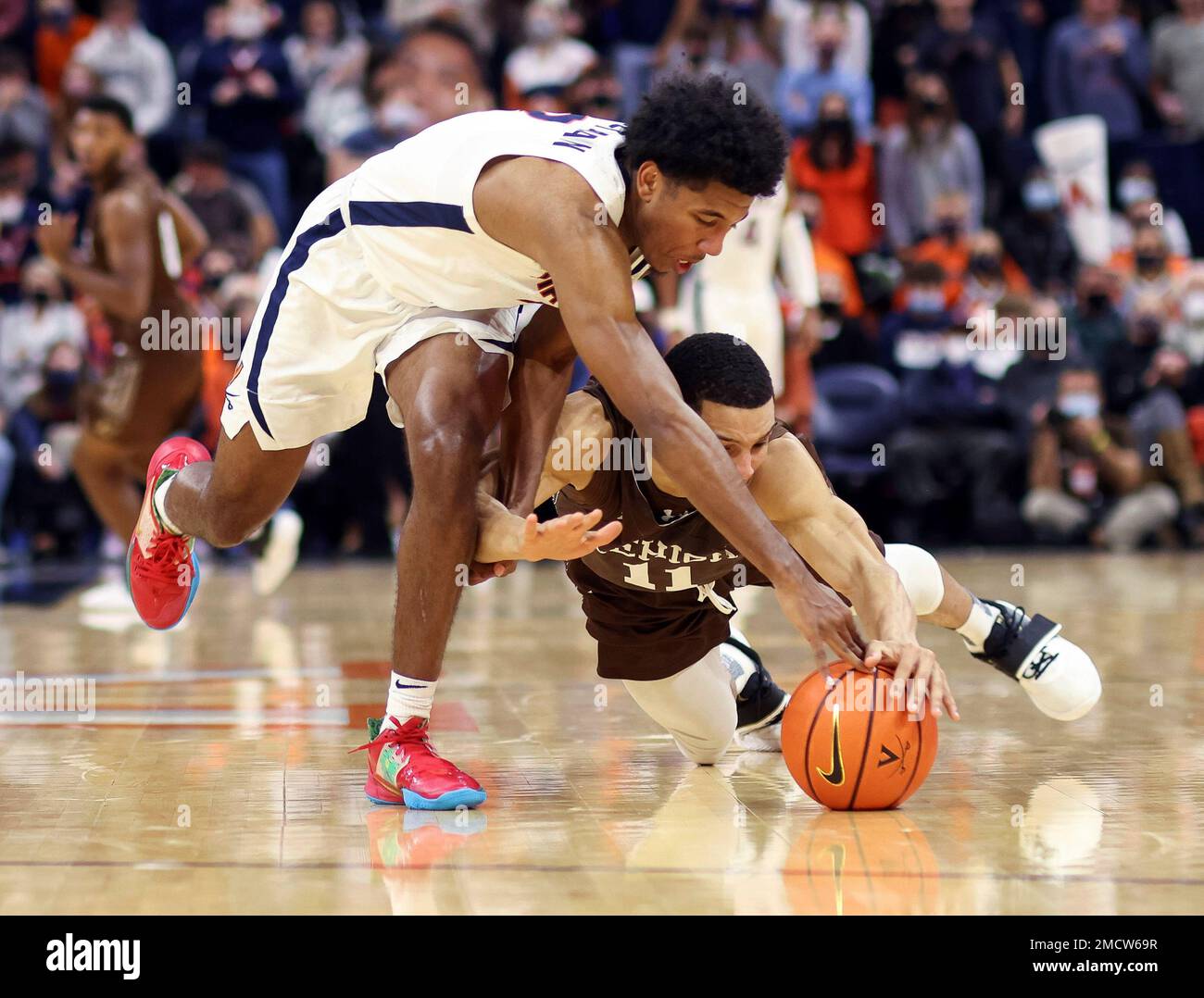 Virginia guard Reece Beekman, left, goes after the ball with Lehigh ...