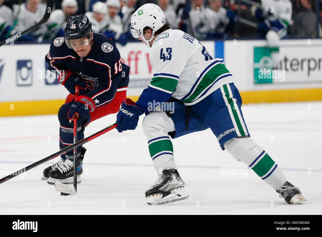 Columbus Blue Jackets' Max Domi, left, carries the puck up ice against ...