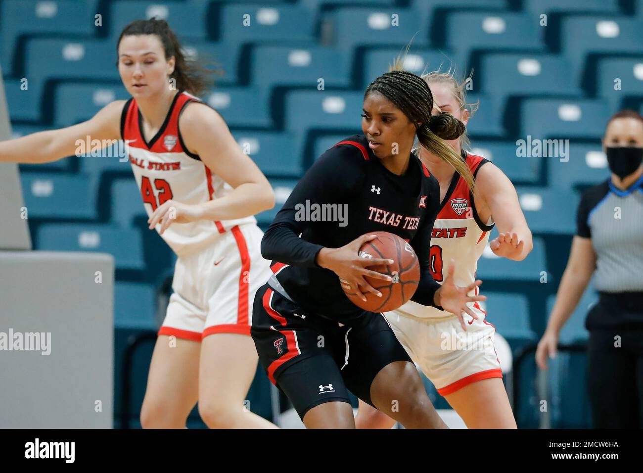 Texas Tech forward Taylah Thomas, middle, spins to the basket between ...