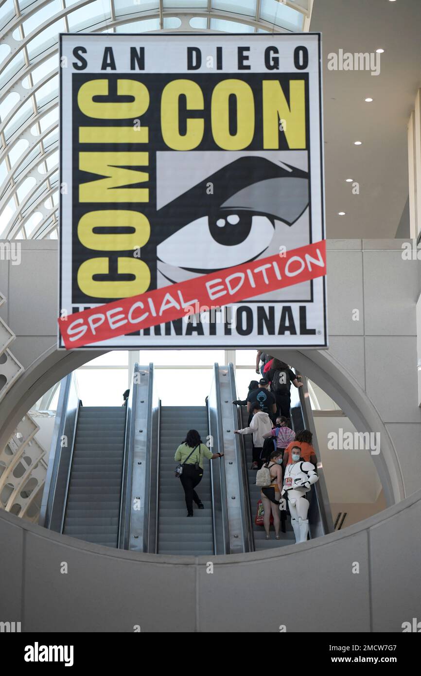 Fans ride the escalator in the convention center on day one of Comic ...