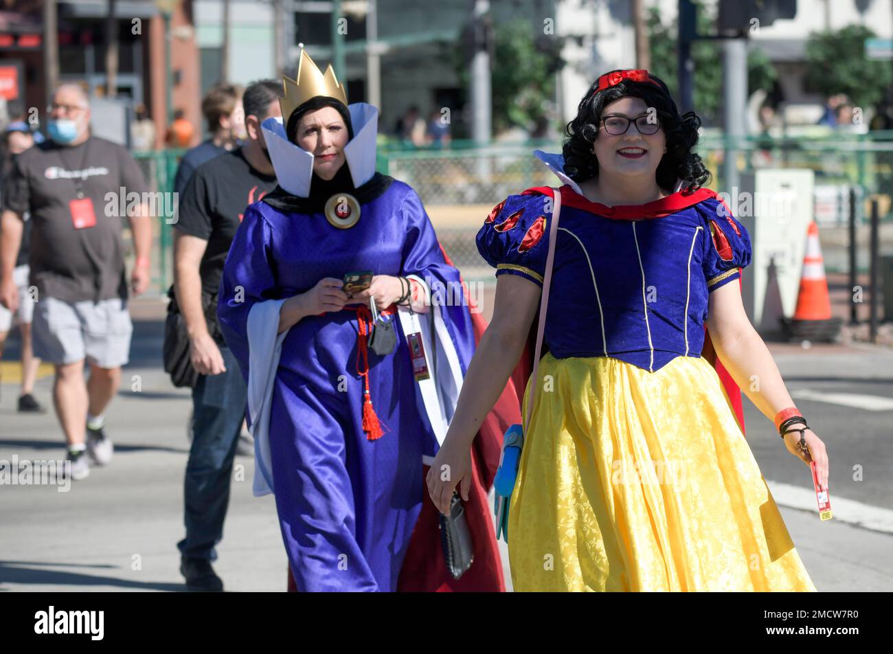 Costumed fans walk in front of the convention center on day one of ...