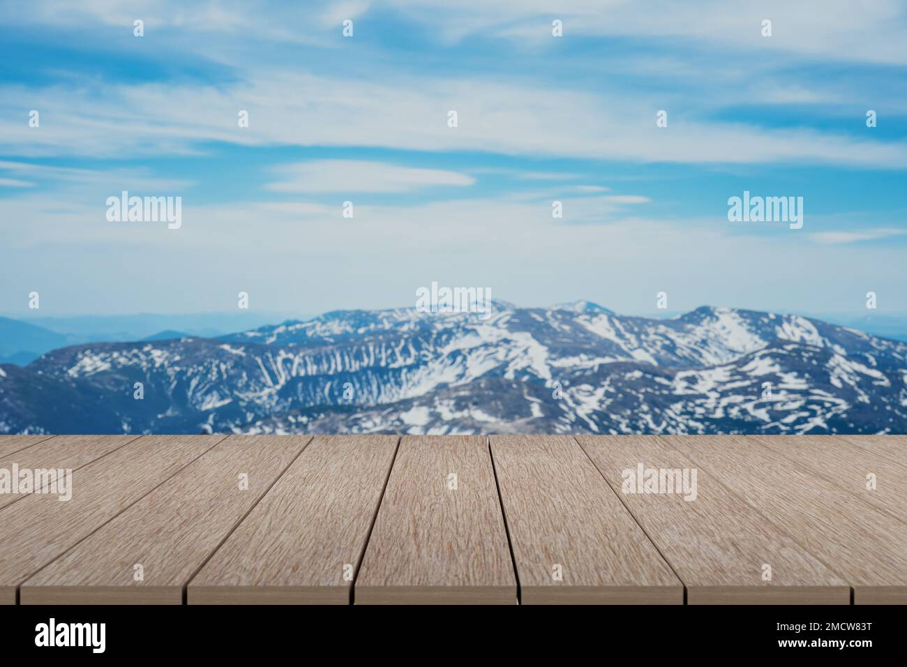 Wooden table with mountains landscape Stock Photo - Alamy