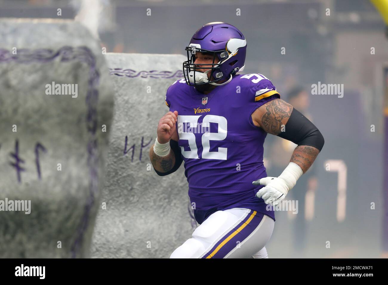 Minnesota Vikings center Mason Cole (52) runs onto the field before an ...