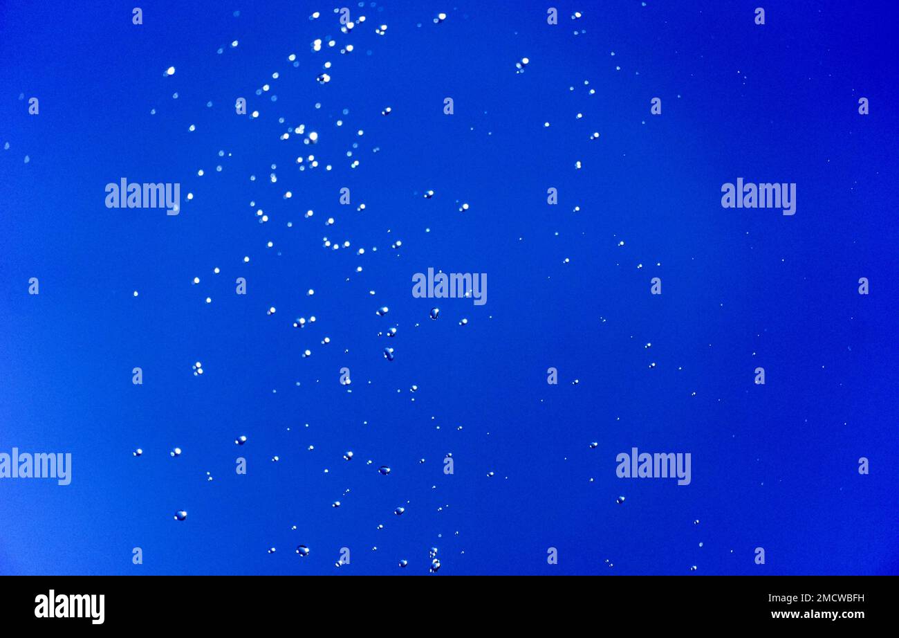 falling water drops on blue sky background Stock Photo - Alamy