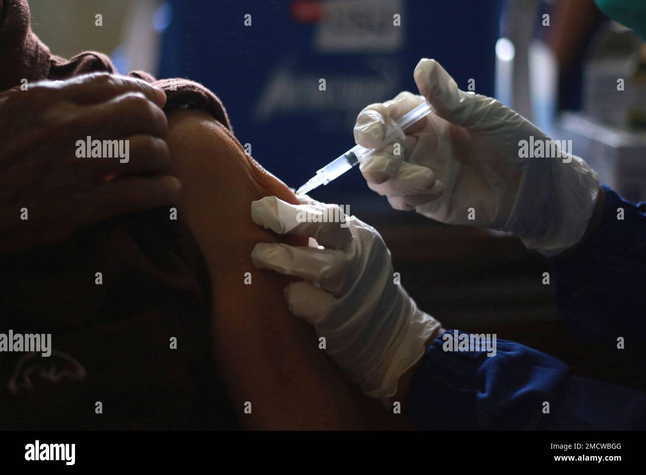 A man receives a shot of Sinovac COVID-19 at North Sumatra University ...