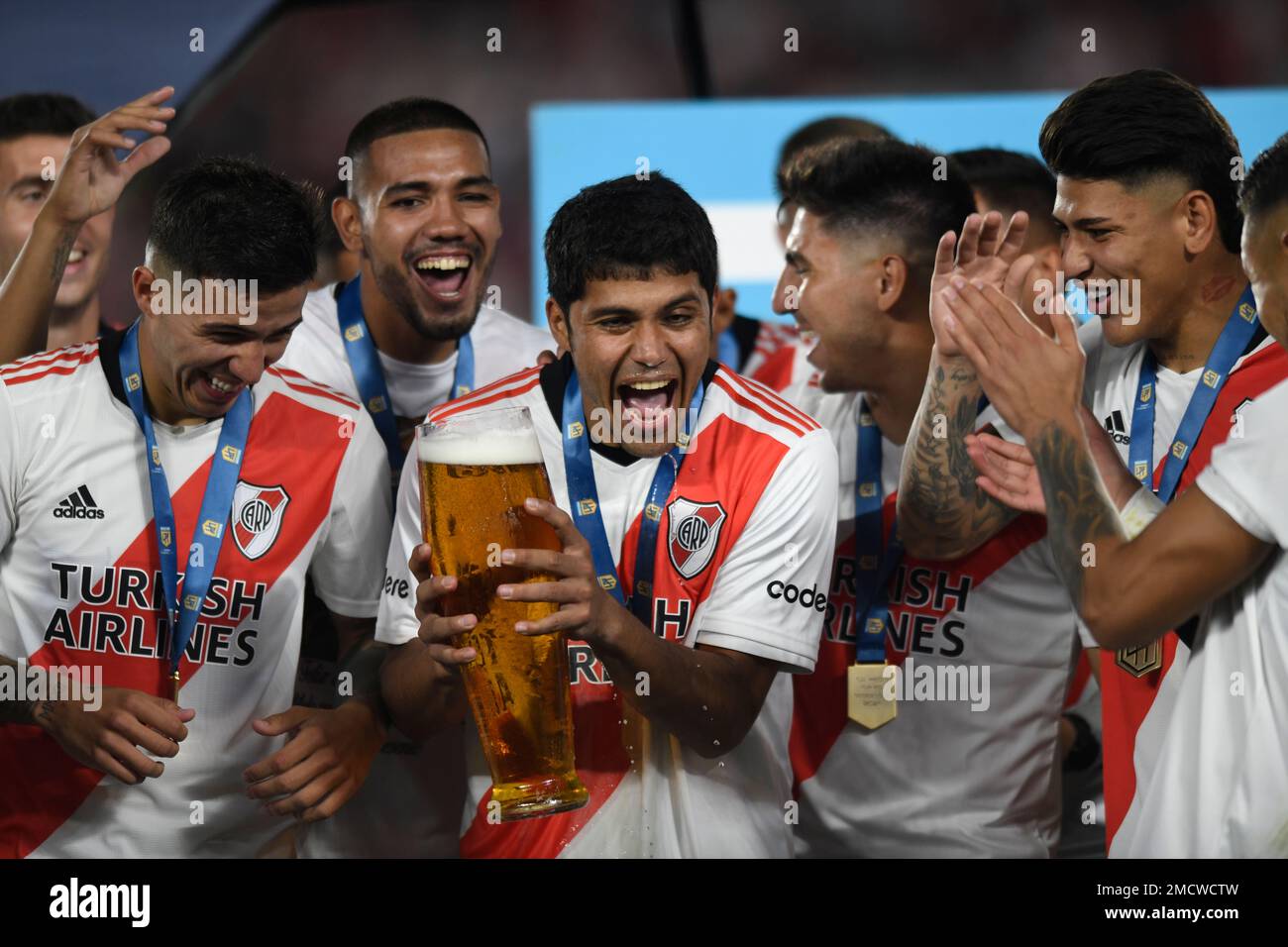 Argentina's River Plate players hold a giant glass of beer and ...