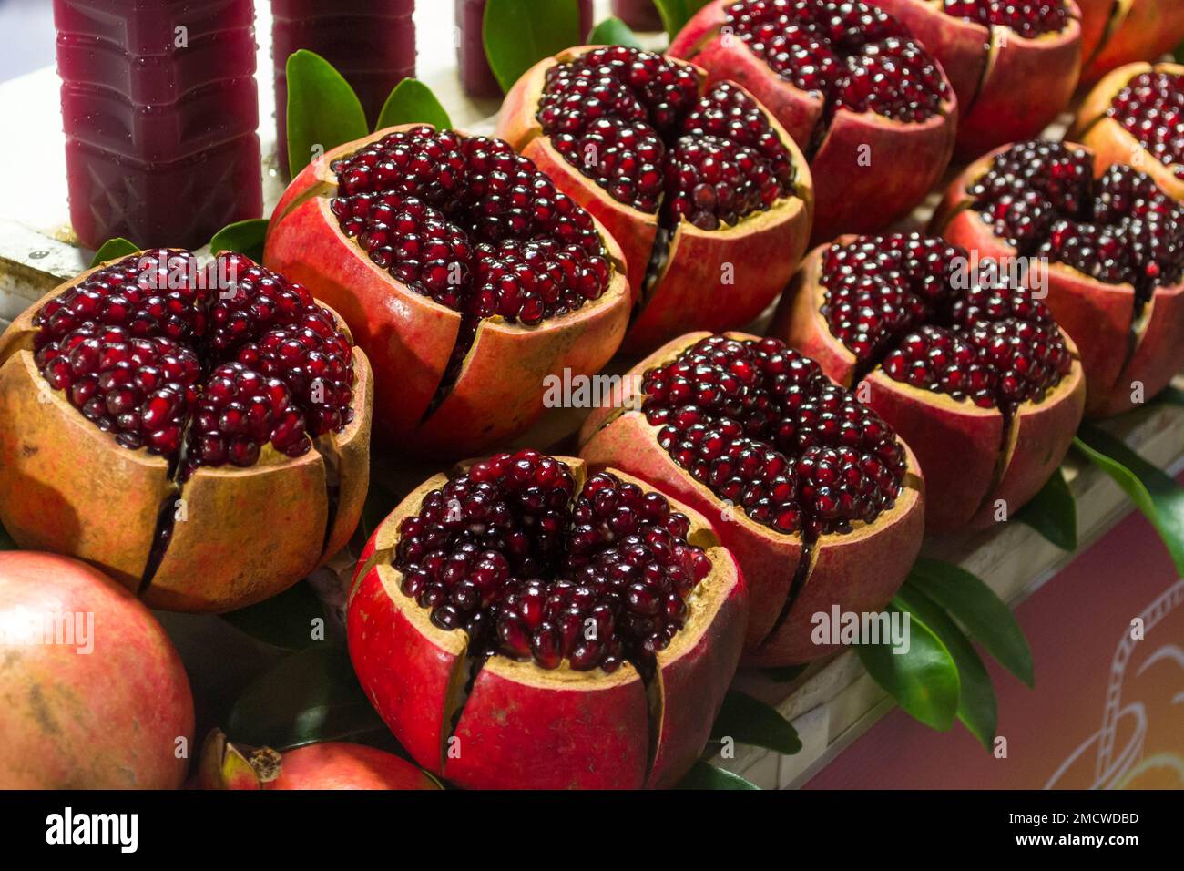 Cut open pomegranate ready to be eaten Stock Photo - Alamy