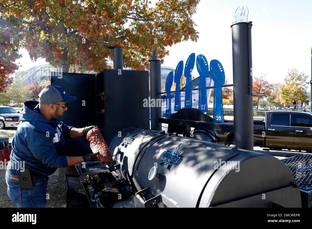 A Dallas Cowboys fan, Johnny Maldonado from Edinburg Texas, loads food ...