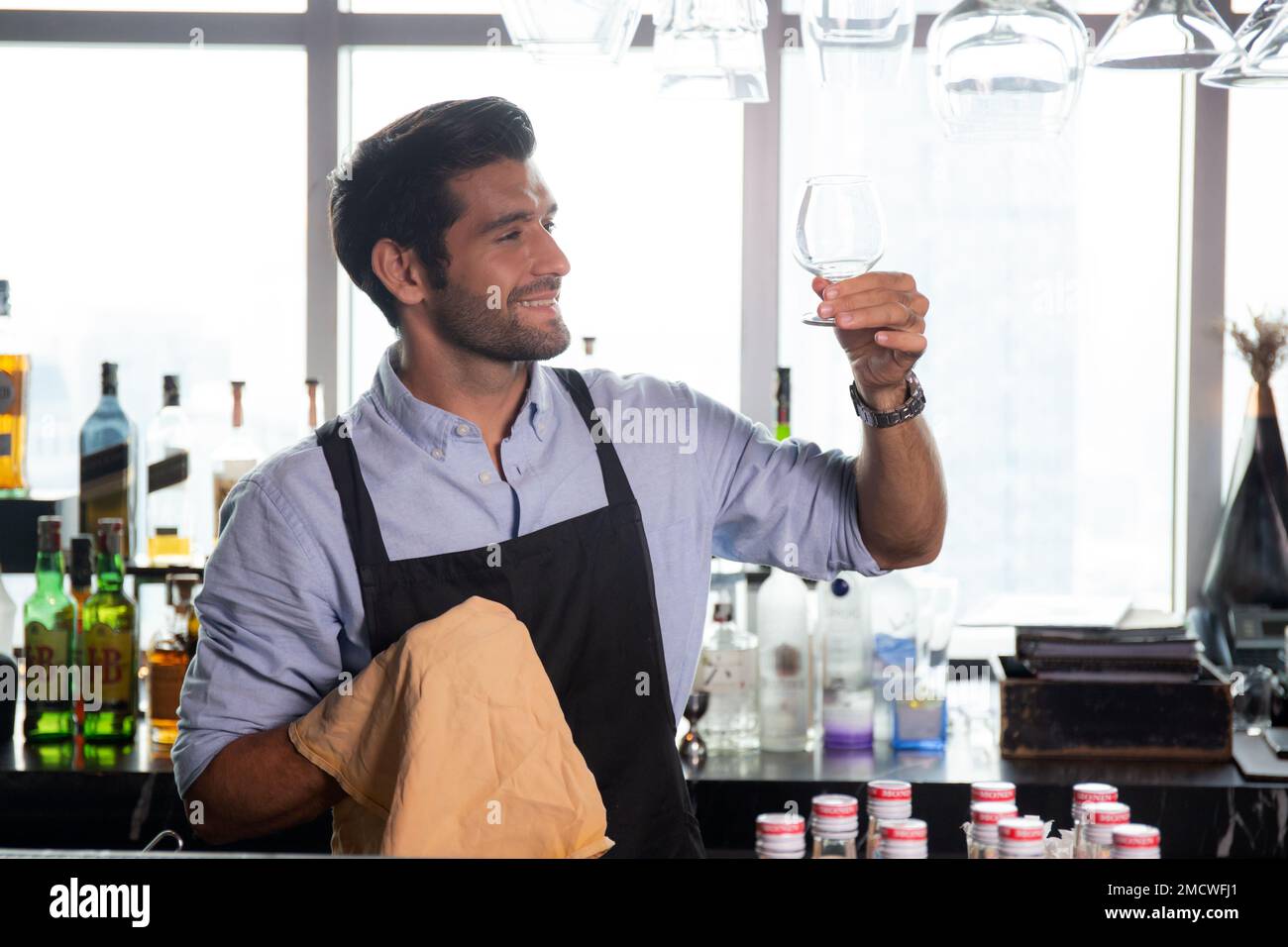 Confident male bartender cleaning bar hi-res stock photography and ...