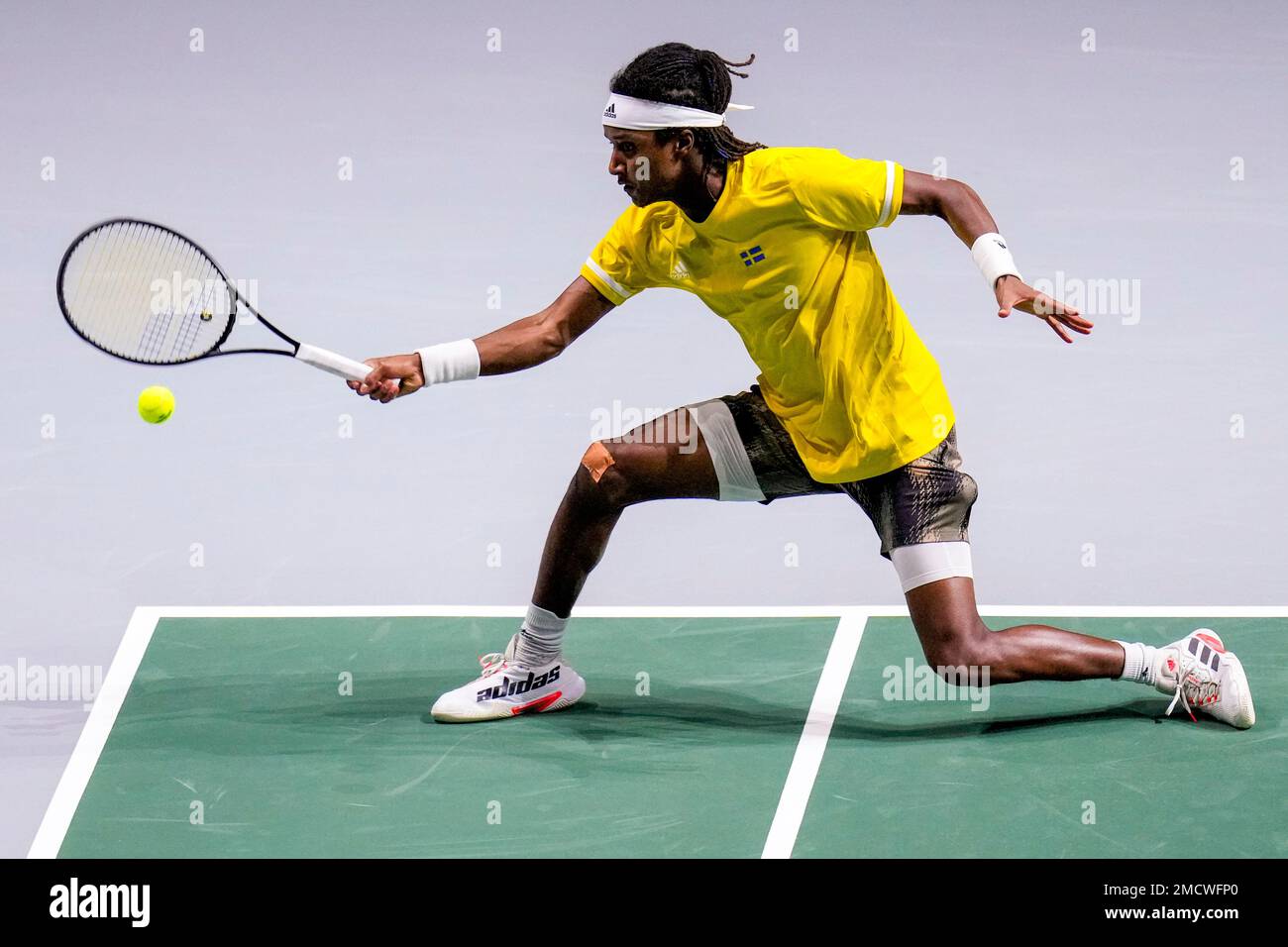 Sweden's Mikael Ymer returns the ball against Canada's Vasek Pospisil ...