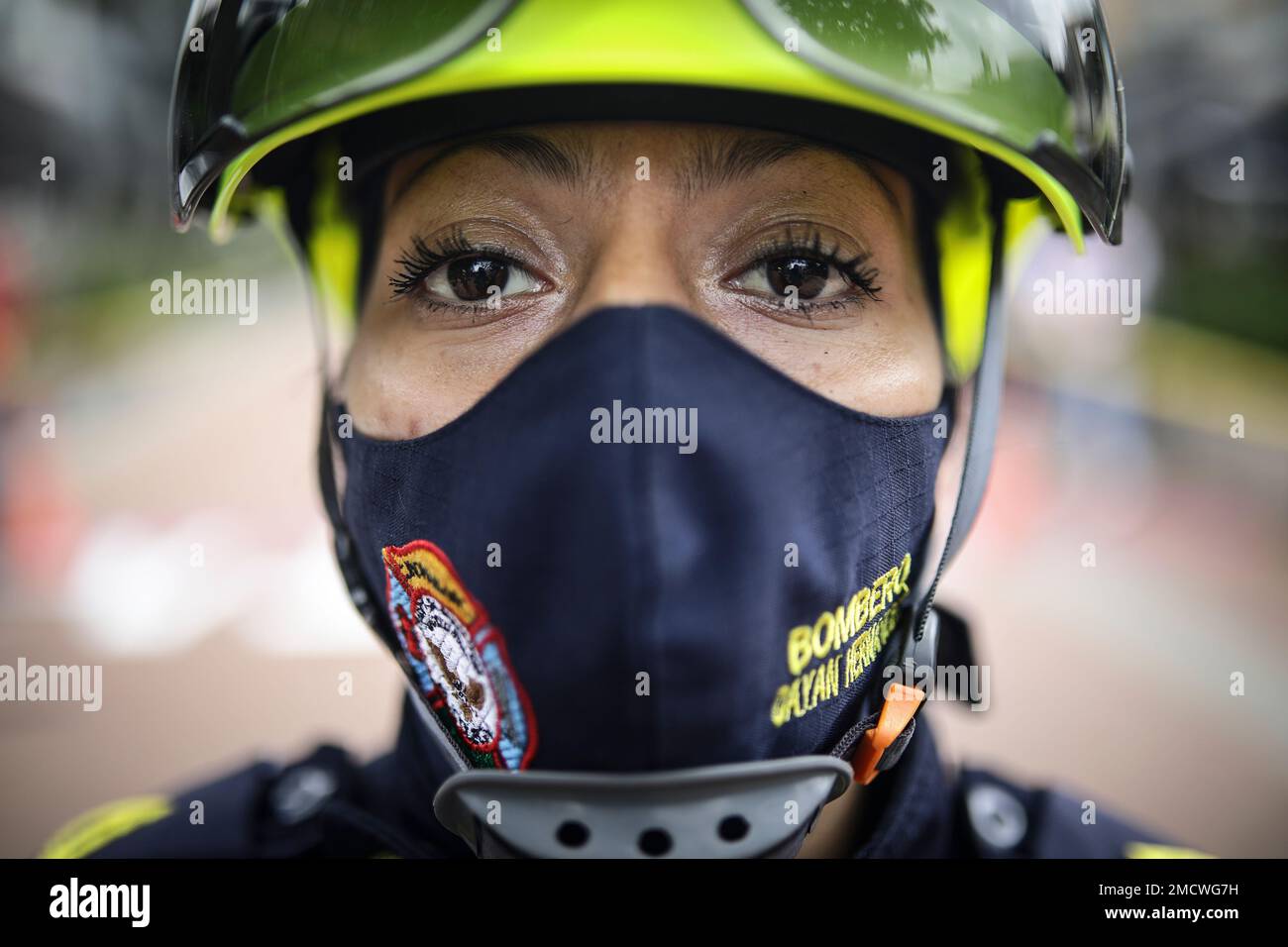 A female firefighter participates in an obstacle course with her male ...